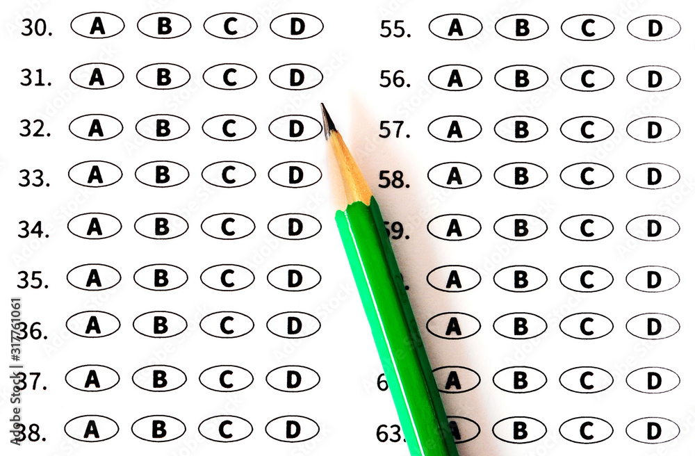 Testing in exercise and exam paper. computer sheet with pencil in ...