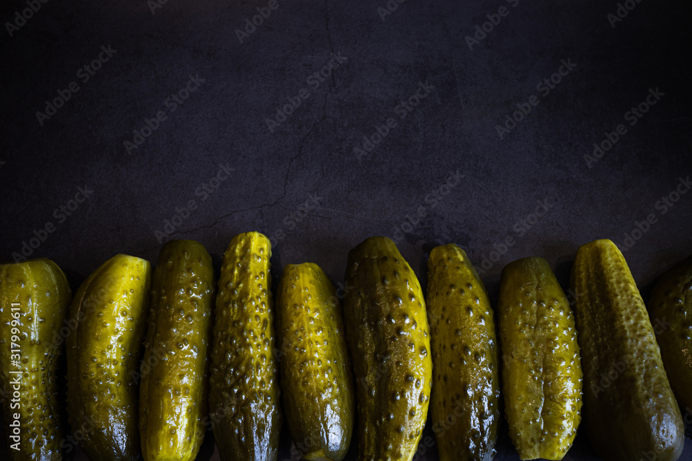 Pickles lie on a dark background. The concept of fermented food. Flat ...