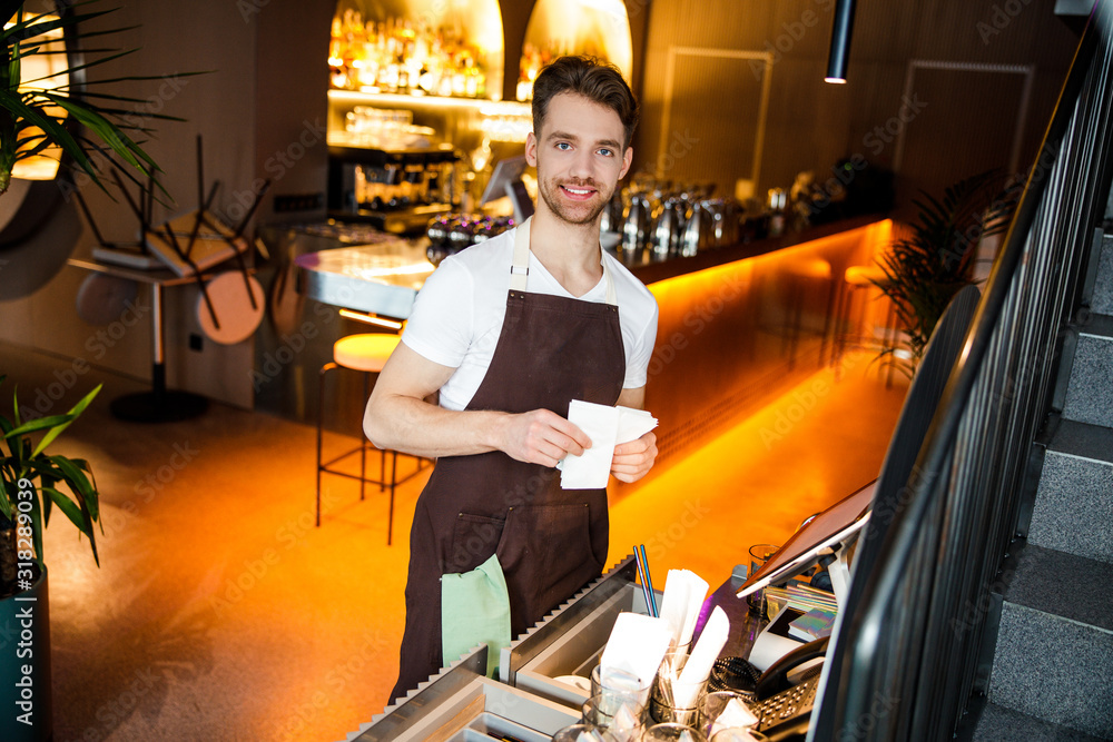 Handsome cafe worker doing his duties at work place Stock Photo | Adobe ...