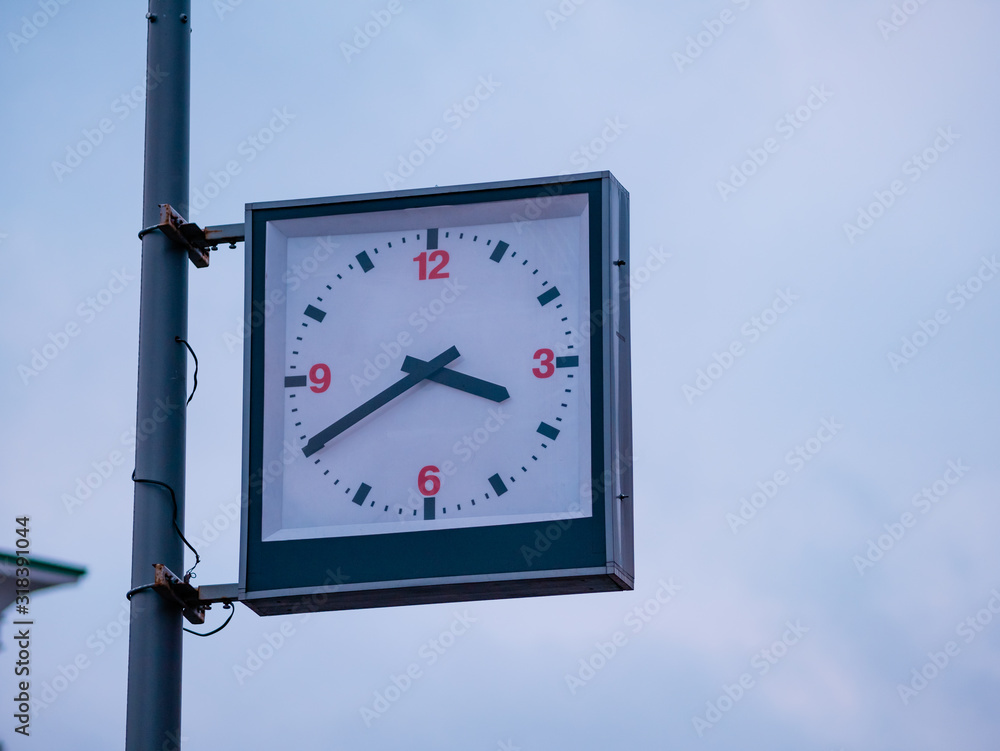 Street clock with a traditional dial and hands arrows for hours and ...