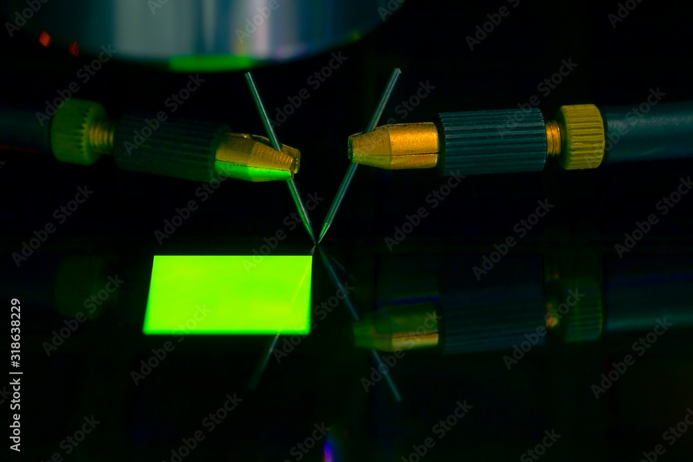 Close up of examining a sample of OLED display with probe station under ...