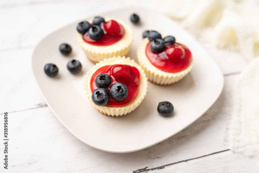Mini cheesecakes with cherry and blueberry topping, sweet summer treat ...