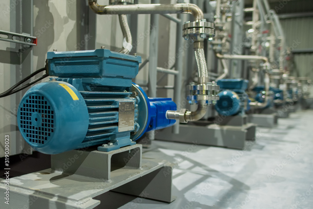 Industrial equipment. Detail of new blue electric motors with pumps on ...