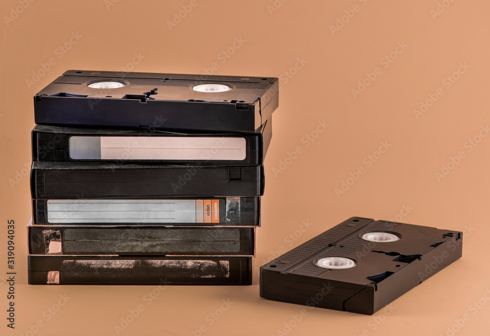 VHS video cassettes on color background with copy space. Stacked old ...