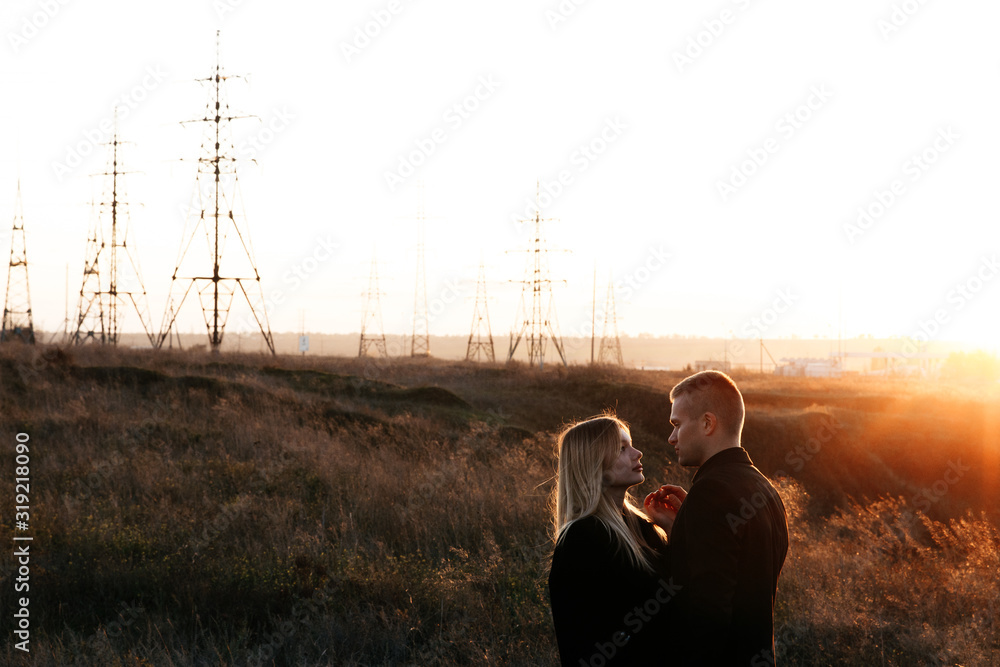 Couple hugging on Power lines background on sunset. Save the planet and ...