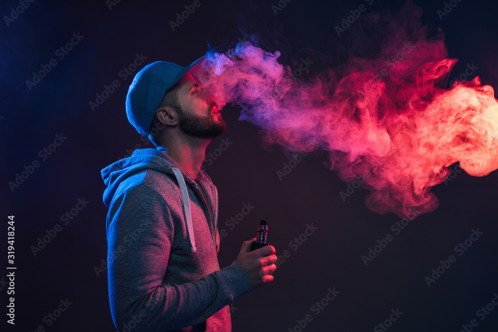 Vaping e-liquid from an electronic cigarette Stock Photo | Adobe Stock