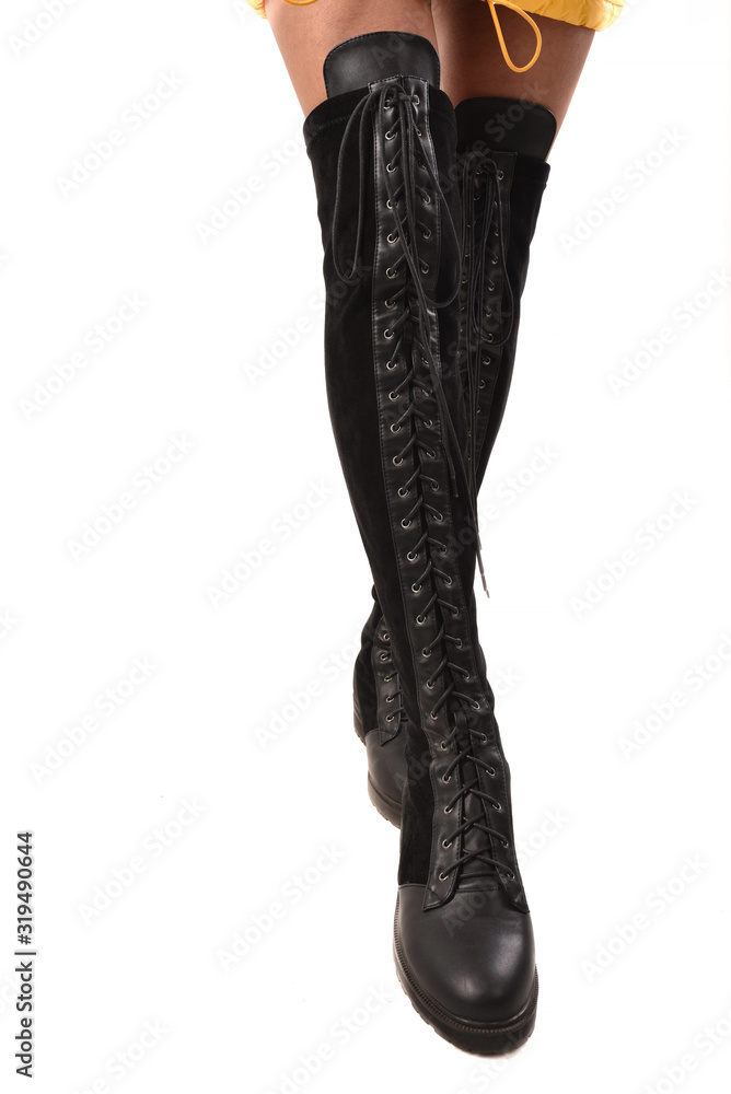 demi seasonal female over knee high boots model shooting in studio on a ...