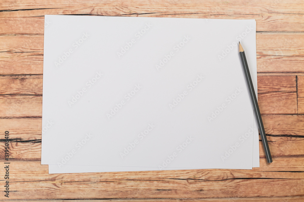 A4 white paper with pen on wooden background. Blank branding template ...