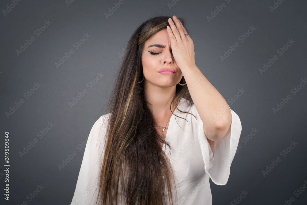 Frustrated brunette woman wearing casual clothes holding hand on ...