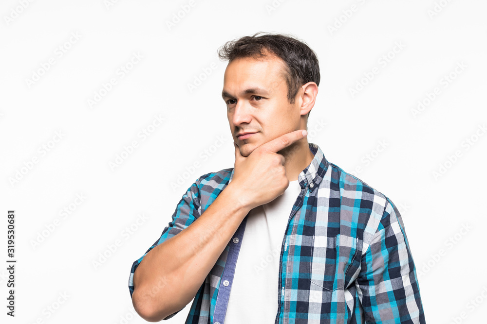 Thoughtful man holding hand on chin pose of indecision, look aside at ...