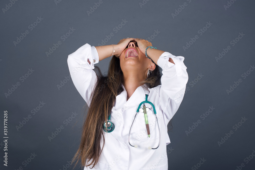 Shocked panic Caucasian doctor girl dressed in medical uniform holding ...