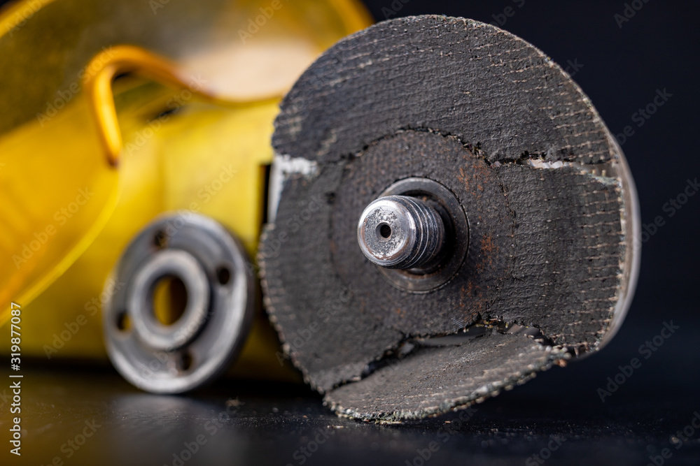 Damaged cutting disc for metal in an angle grinder. Power tools in a ...