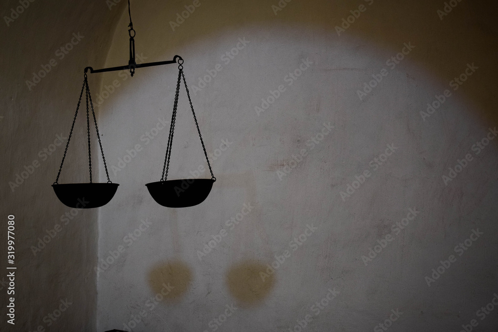 Old hanging scale as a symbol of justice, representing threat in a dark ...