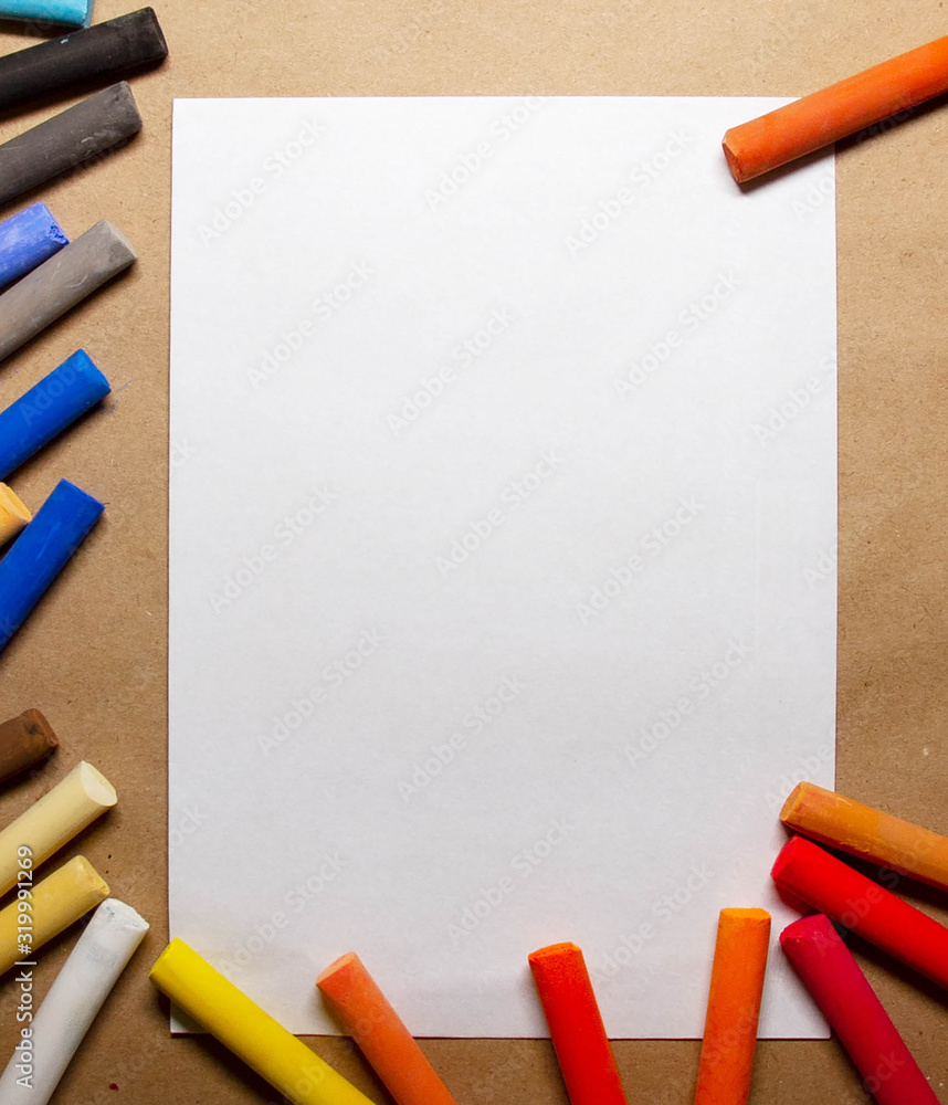 Flat lay top view of art workplace, craft papper with white paper and ...