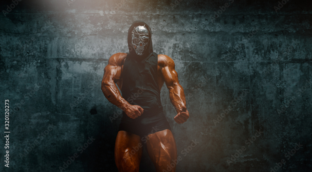 Mysterious Muscular man hiding behind mask Flexing Muscles. Bodybuilder ...