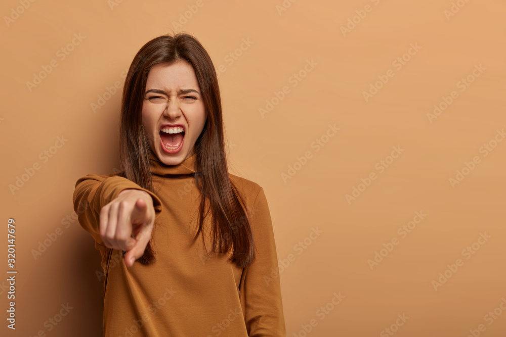 Foto de Stock Outraged beautiful woman blames and points at you with ...