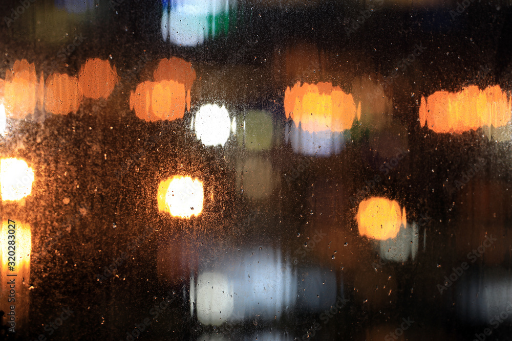 Rain Drops Falling on window with bokeh light effects in the background ...