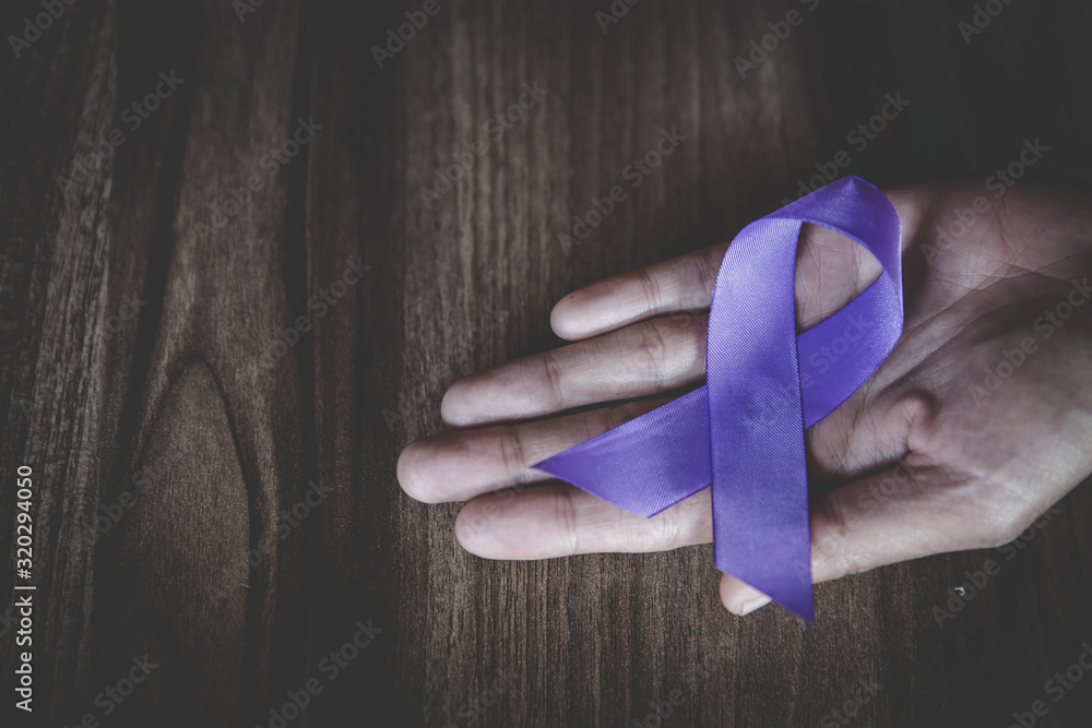 Purple ribbon in a woman's hand, Domestic Violence Awareness Month ...