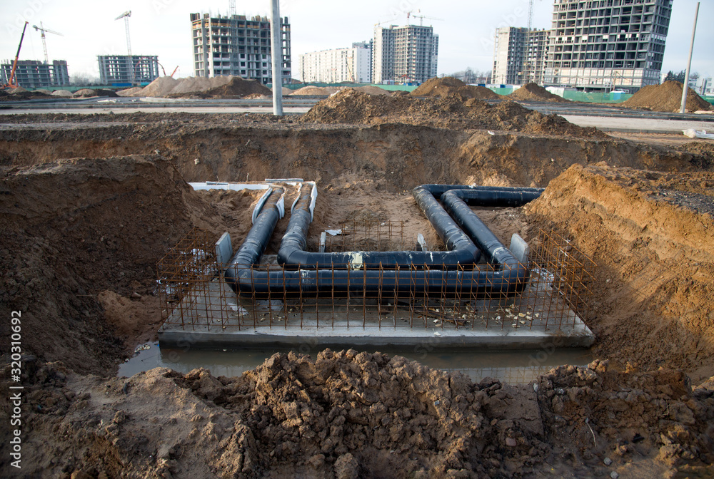 Laying of underground storm sewer pipes in ditch. Installation of water ...