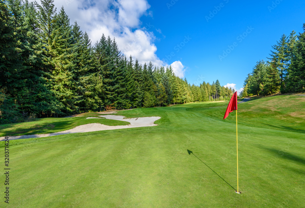 Golf course with gorgeous green, sand bunker and golf flag and real ...