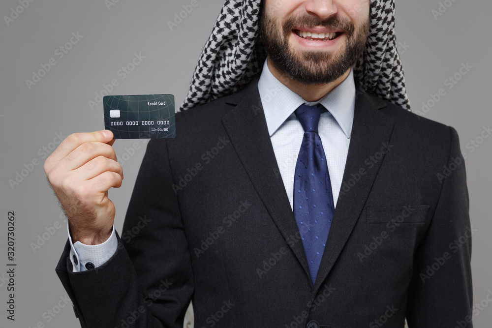 Cropped image of smiling arabian muslim businessman in keffiyeh kafiya ...
