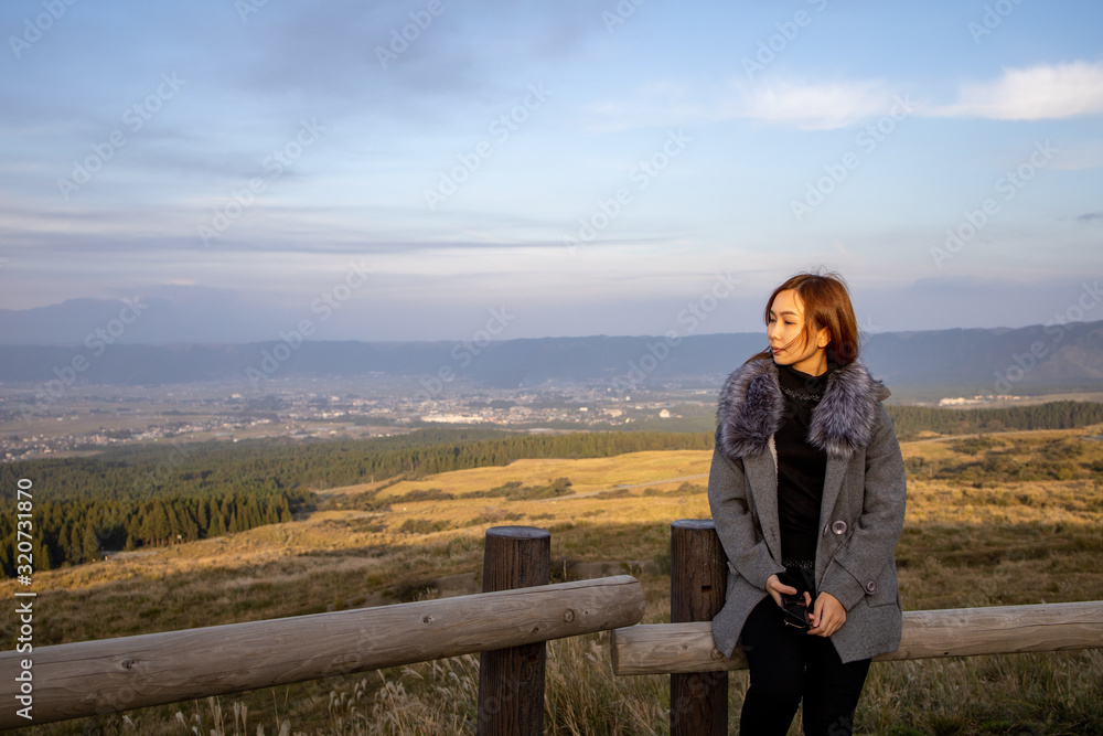 Lonely girl in Area of Aso active volcano background with smoke at ...