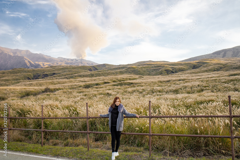 Lonely girl in Area of Aso active volcano background with smoke at ...