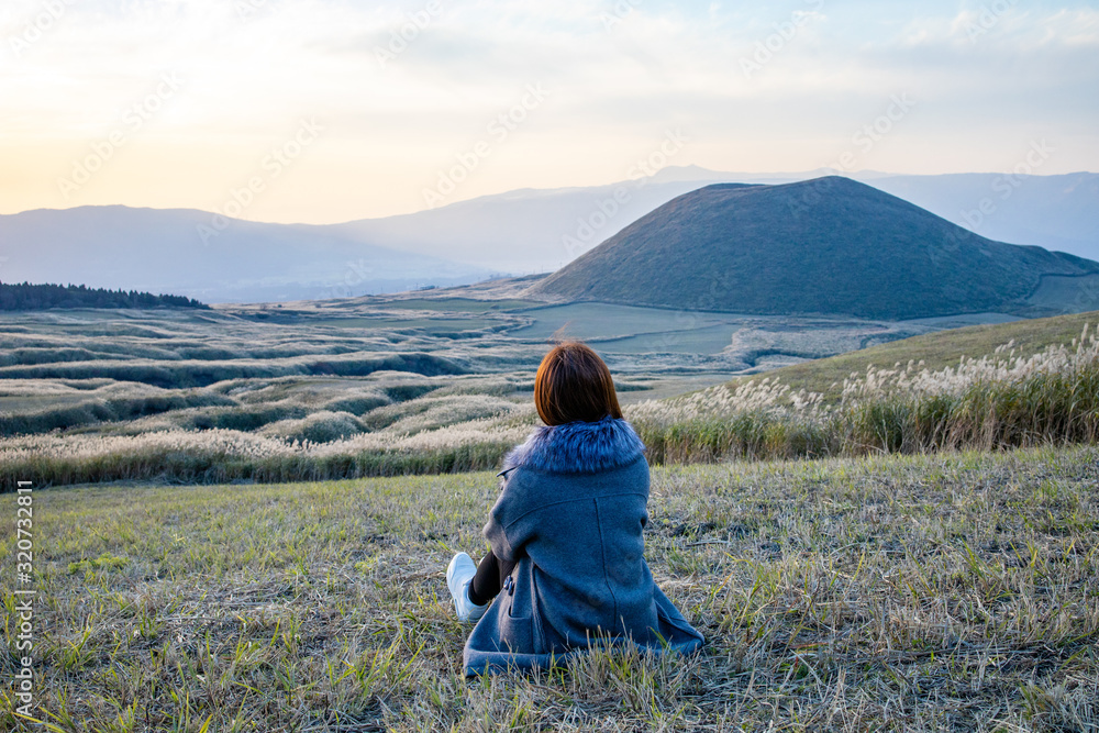 Lovely cute japanese girl sitting on Aso active volcano background with ...