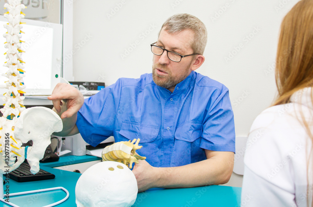 The doctor osteopath and chiropractor in the hospital explains to the ...