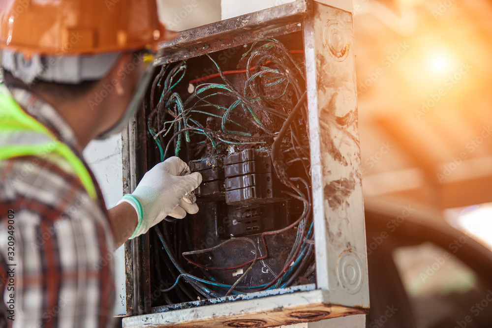 The technician is investigating the cause of the fire, short circuit ...