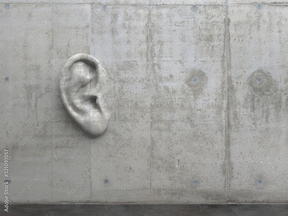 Cement sculpture in the shape of a human ear on a concrete wall ...