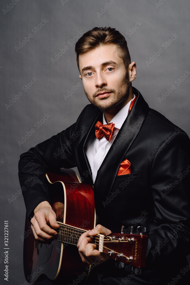 good looking formal business man wearing black suit sitting and holding ...