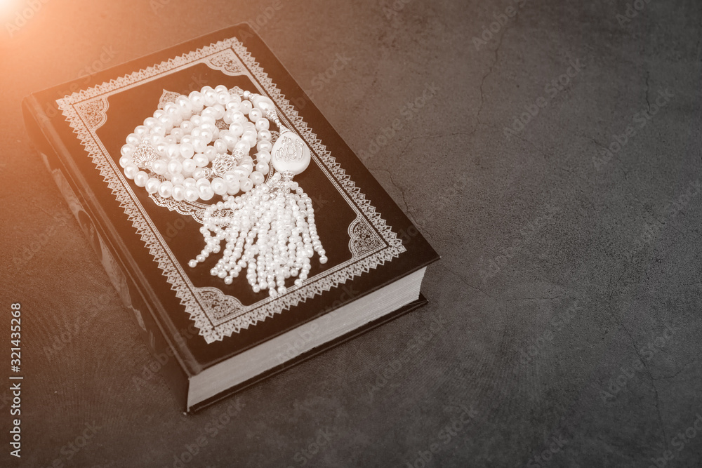 Muslim islamic faith concept Koran book , white rosary with the ...