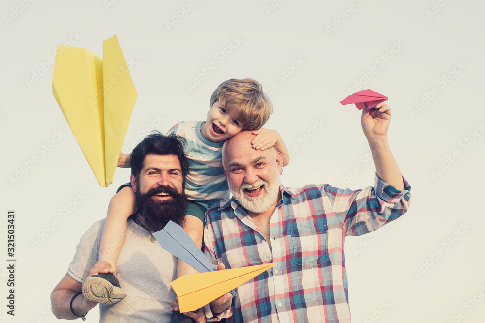 Grandfather, father and son are hugging and having fun together. Kid ...
