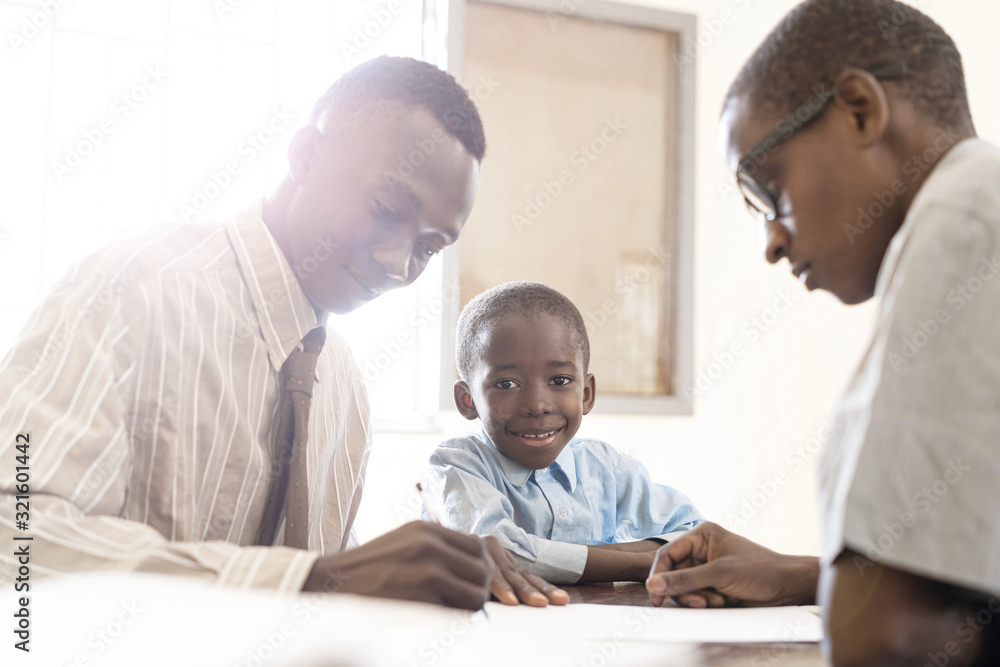 African dad father and child son signing contract for back to school or ...