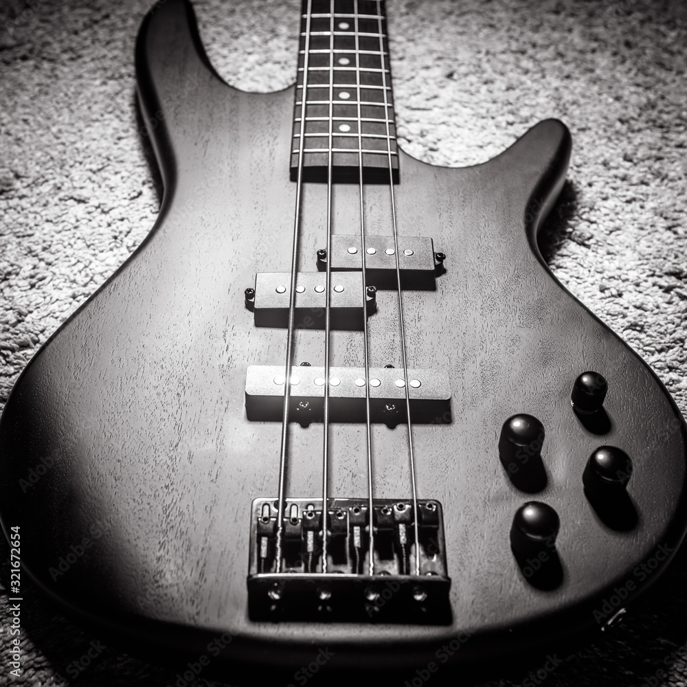 Bass electric guitar with four strings in black and white. Popular rock ...