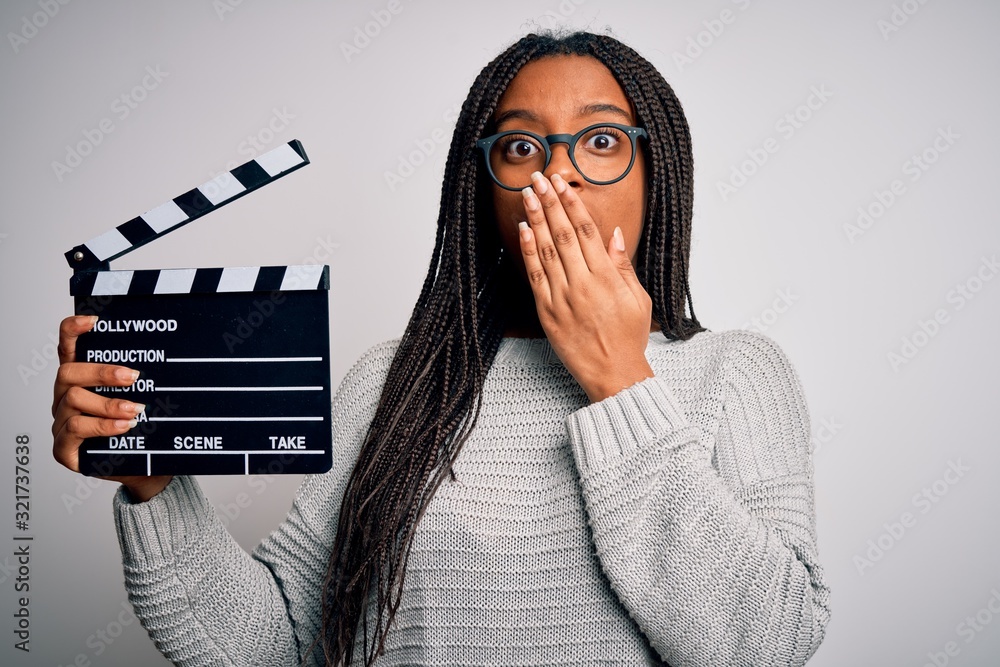 Young african american director girl filming a movie using clapboard ...