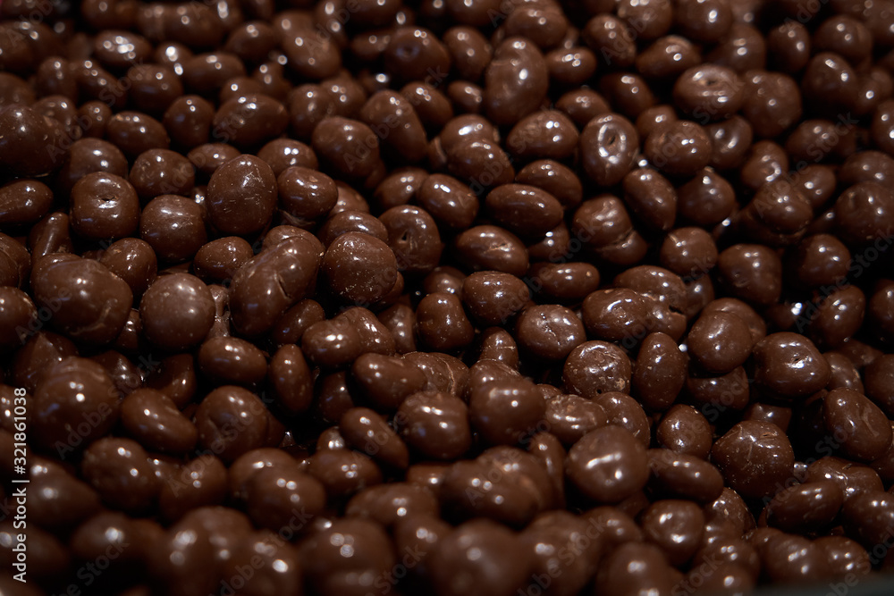 Almonds in chocolate glaze. Nuts in milk chocolate. Brown jelly beans ...