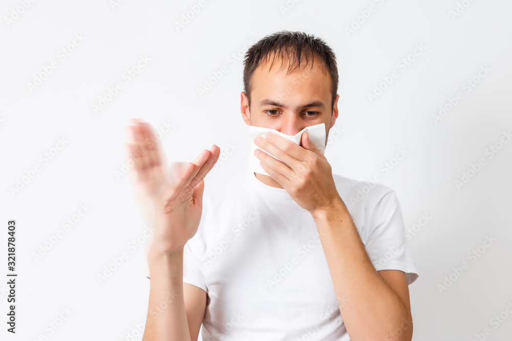 Closeup portrait of young man, disgust on his face, pinches his nose ...