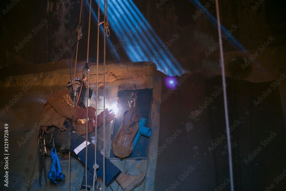 Abseiler wearing safety harness helmet leather jacket glove conducting ...