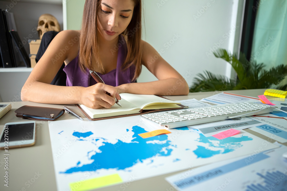 The image of a beautiful young business woman working tensely with a ...