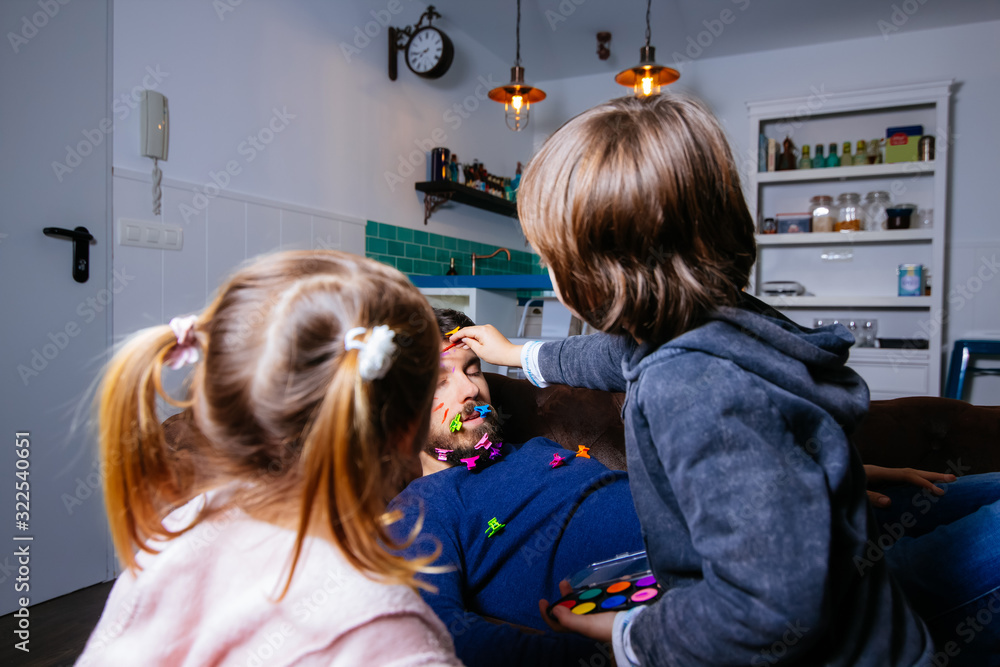 Children doing mischief to their father while he sleeps Stock Photo ...
