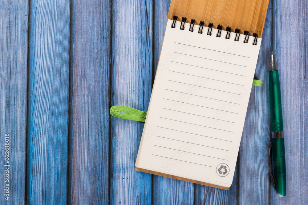 top view of blank open notebook paper on background, office equipment ...