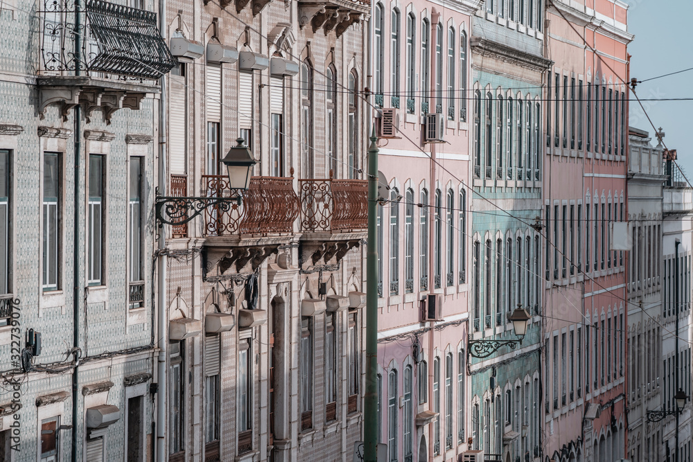 Line up of multi colored tiled facade buildings in Alfama district of ...
