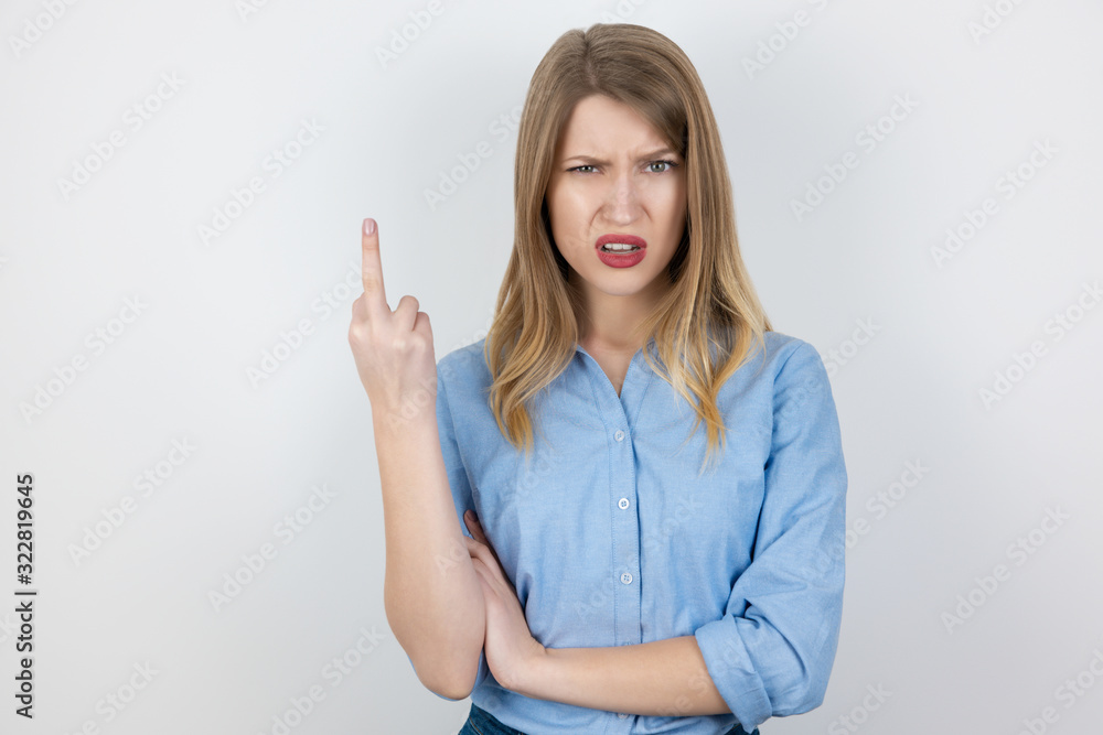 portrait of rude blond brutal woman showing fuck off sign looking harsh ...