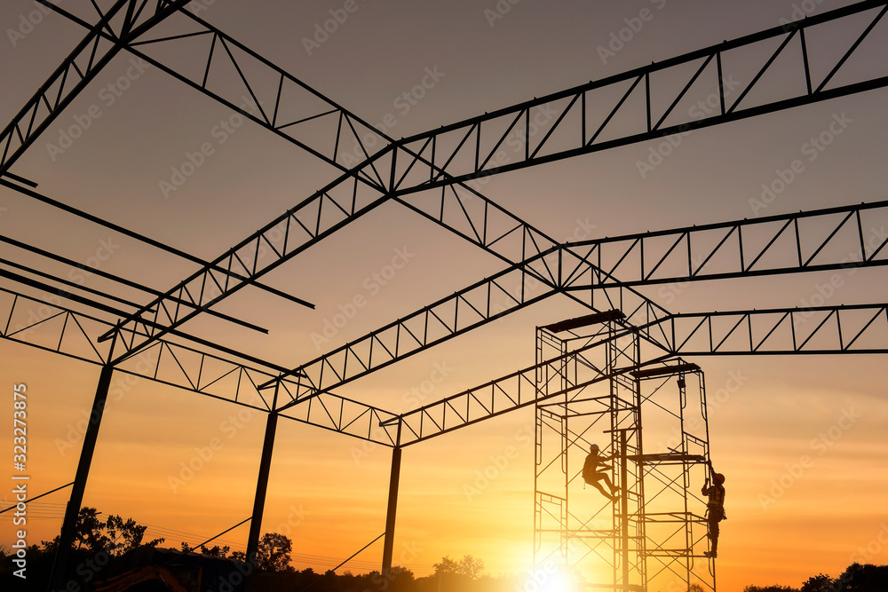 Construction worker wearing safety work at high uniform on scaffolding ...
