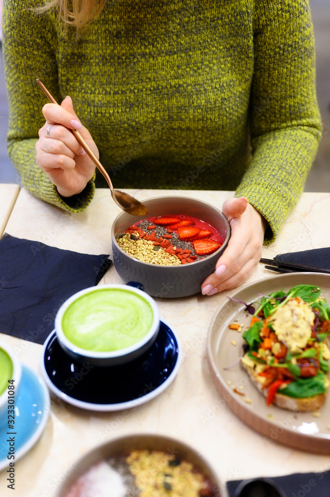 raw healthy food breakfast and woman, ready to eats. smoothie bowl ...