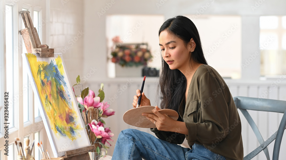 Woman Artist Works on Abstract acrylic painting in the art studio ...