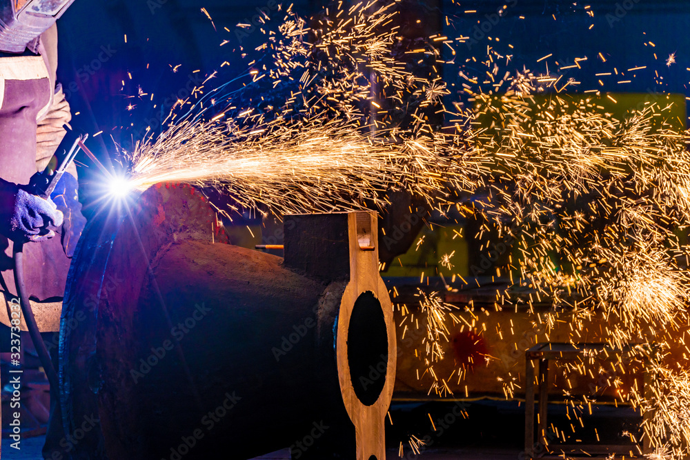 Welding with a graphite electrode, a lot of sparks fly in different ...