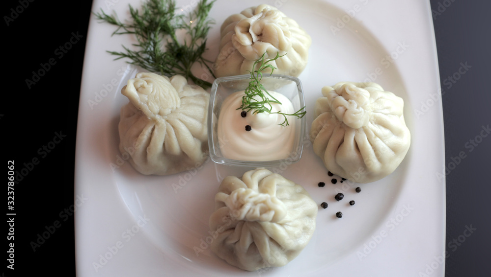 Georgian dumplings Khinkali with meat on metal plate close-up. Khinkali ...
